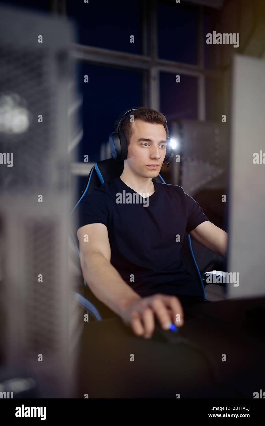 Professional gamer playing online video game at night time Stock Photo ...