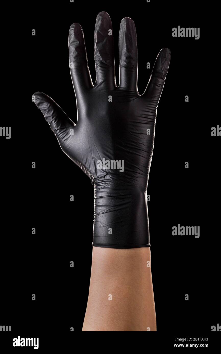 Hand in black gloves showing five fingers and palm isolated on black ...