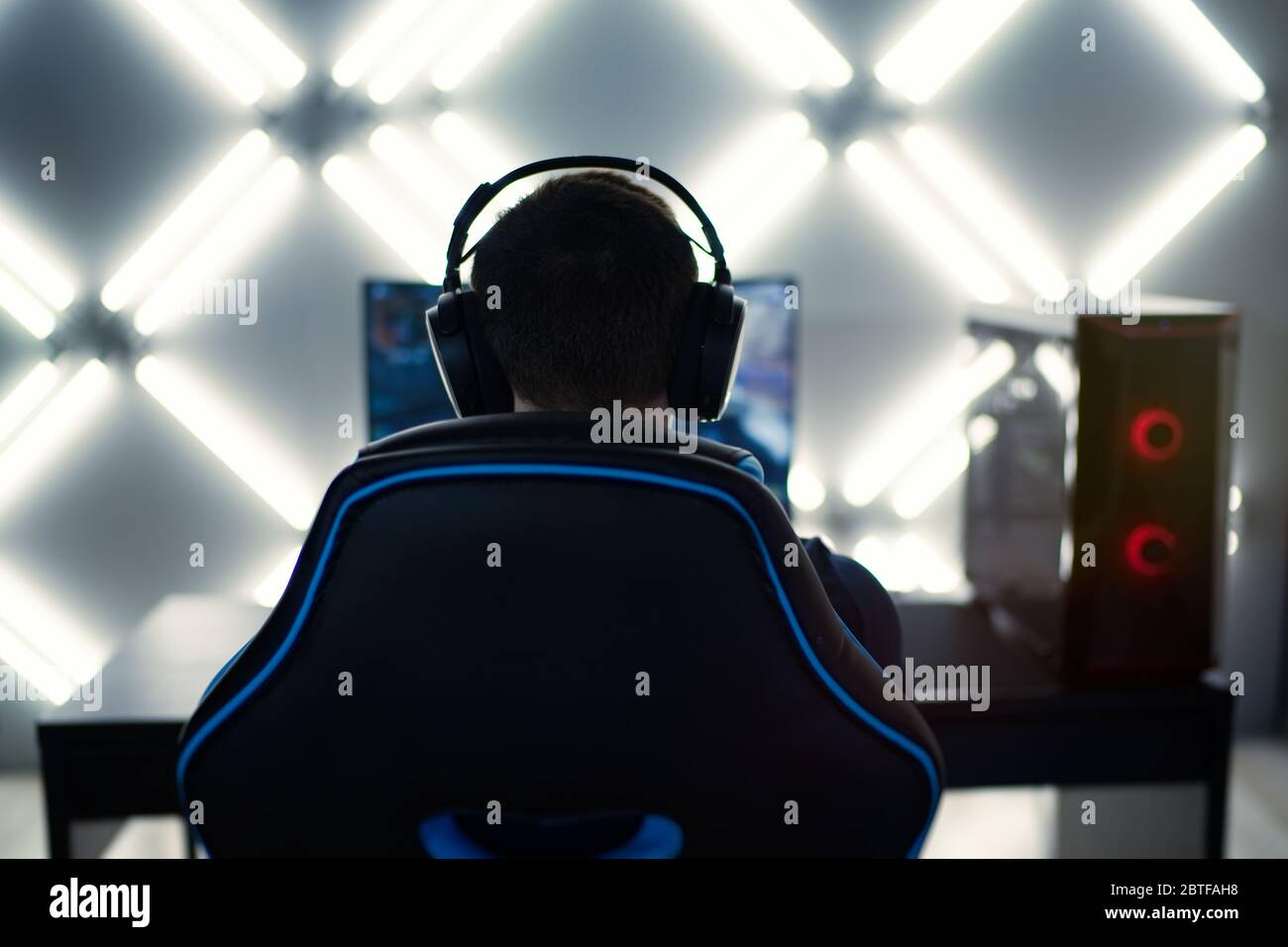 Professional gamer playing online video game at night time Stock Photo ...
