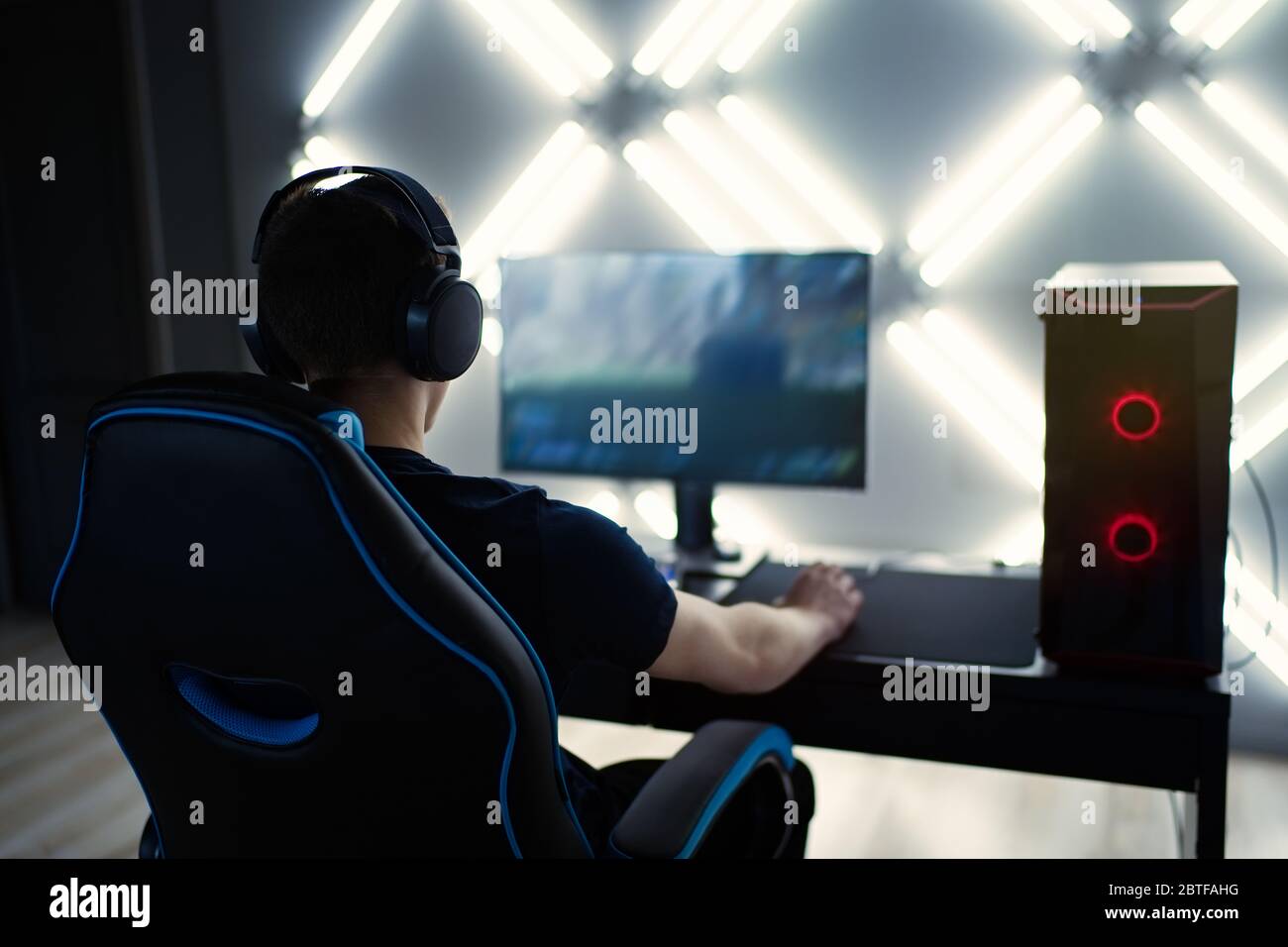 Professional gamer playing online video game at night time Stock Photo ...