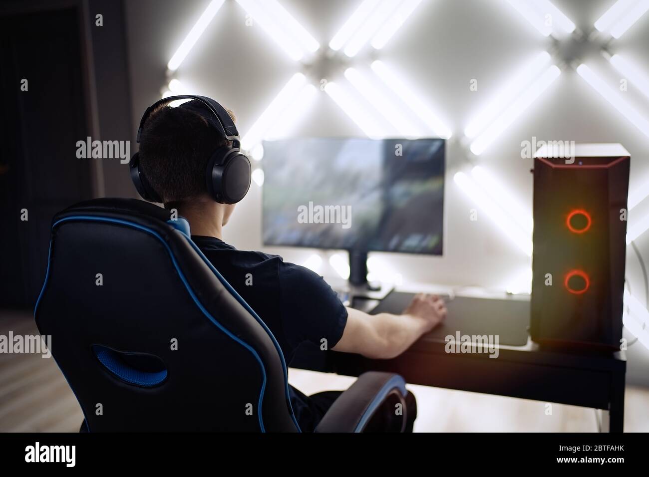 Professional gamer playing online video game at night time Stock Photo ...