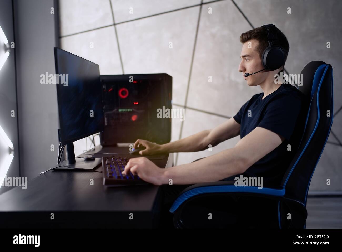 Professional gamer playing online video game at night time Stock Photo ...