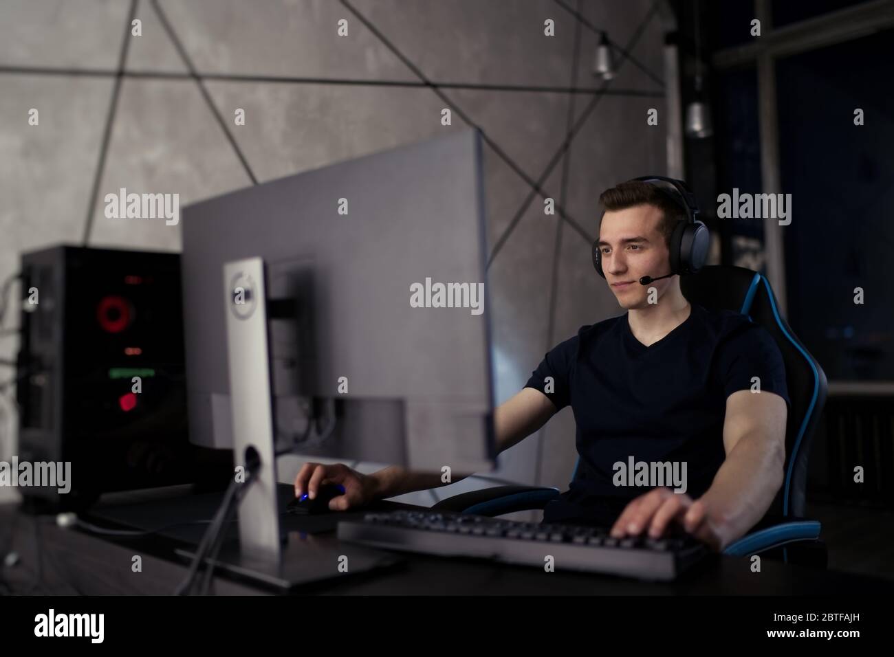 Professional gamer playing online video game at night time Stock Photo ...