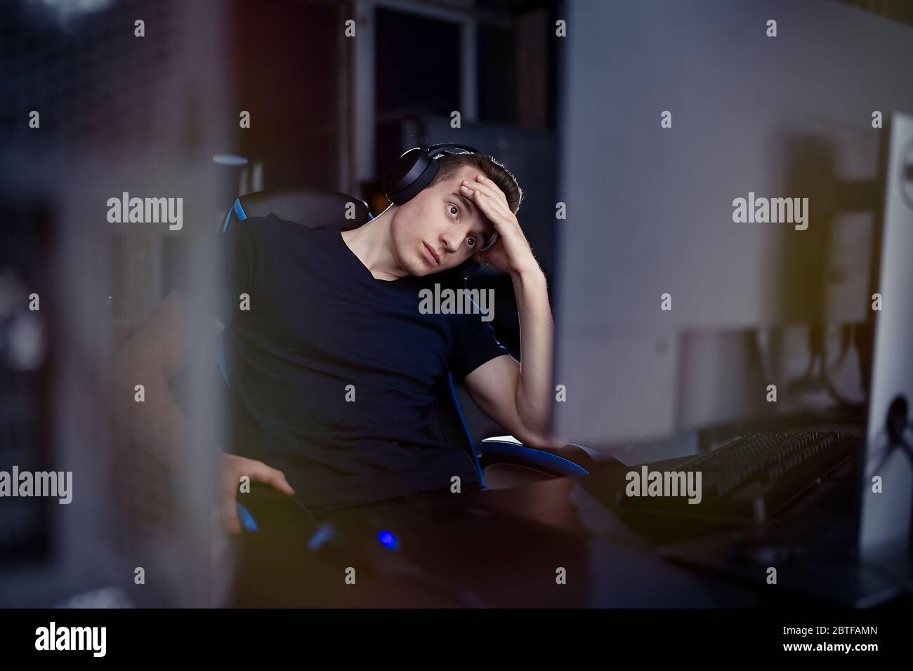 Young upset gamer playing online video games on computer and feel ...