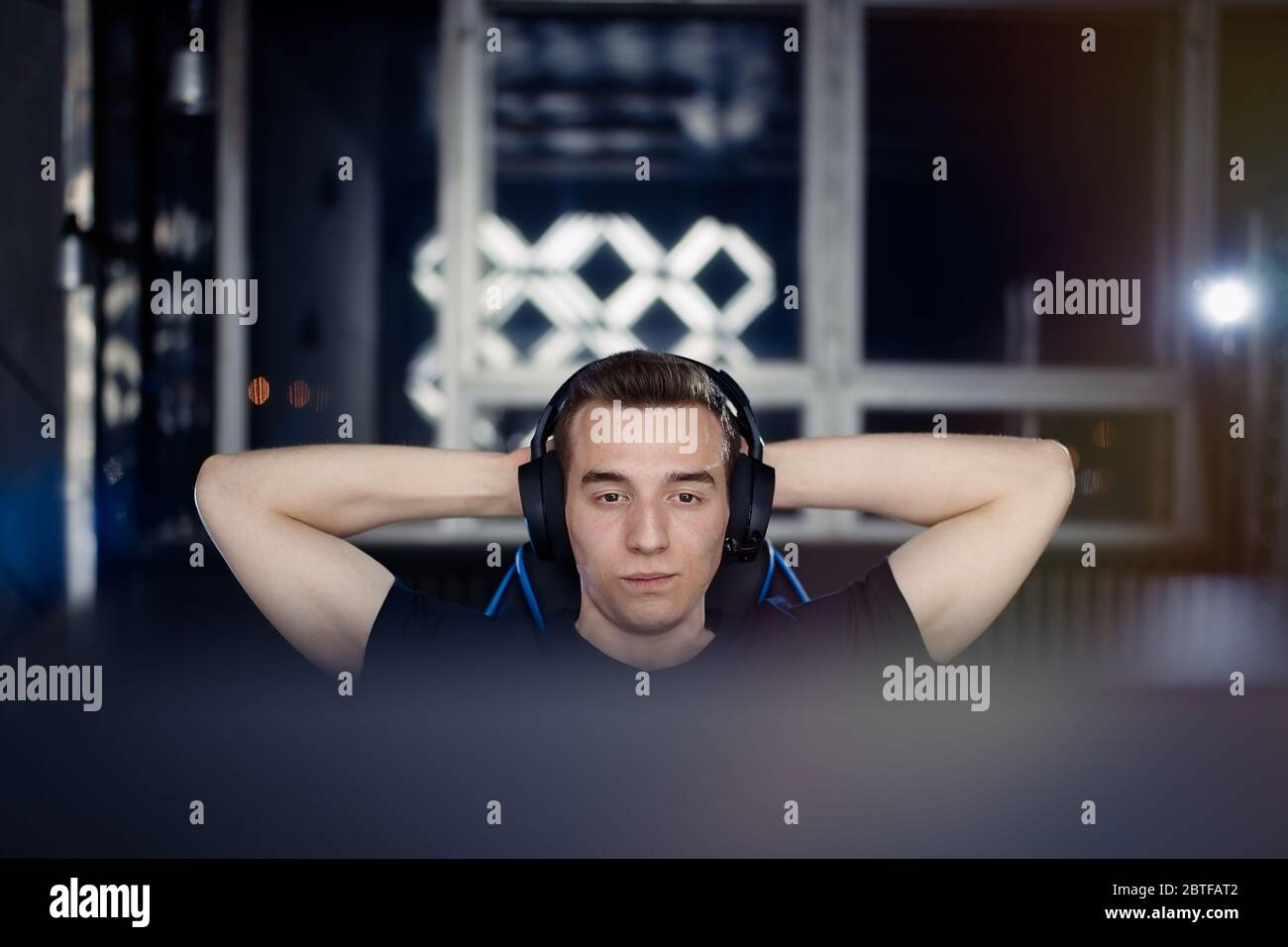 Young gamer playing online video games on computer and satisfied after ...