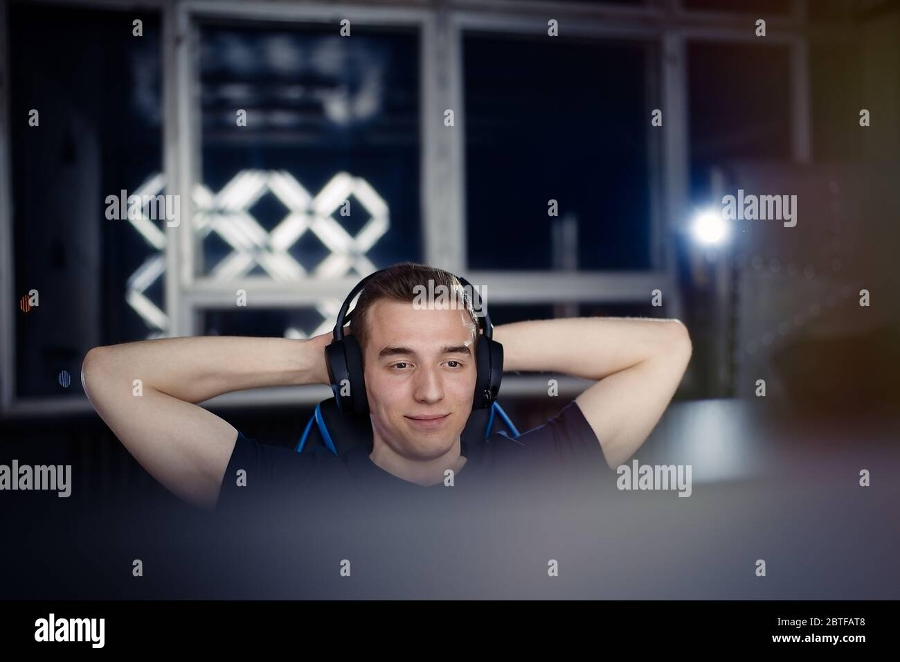 Young gamer playing online video games on computer and satisfied after ...