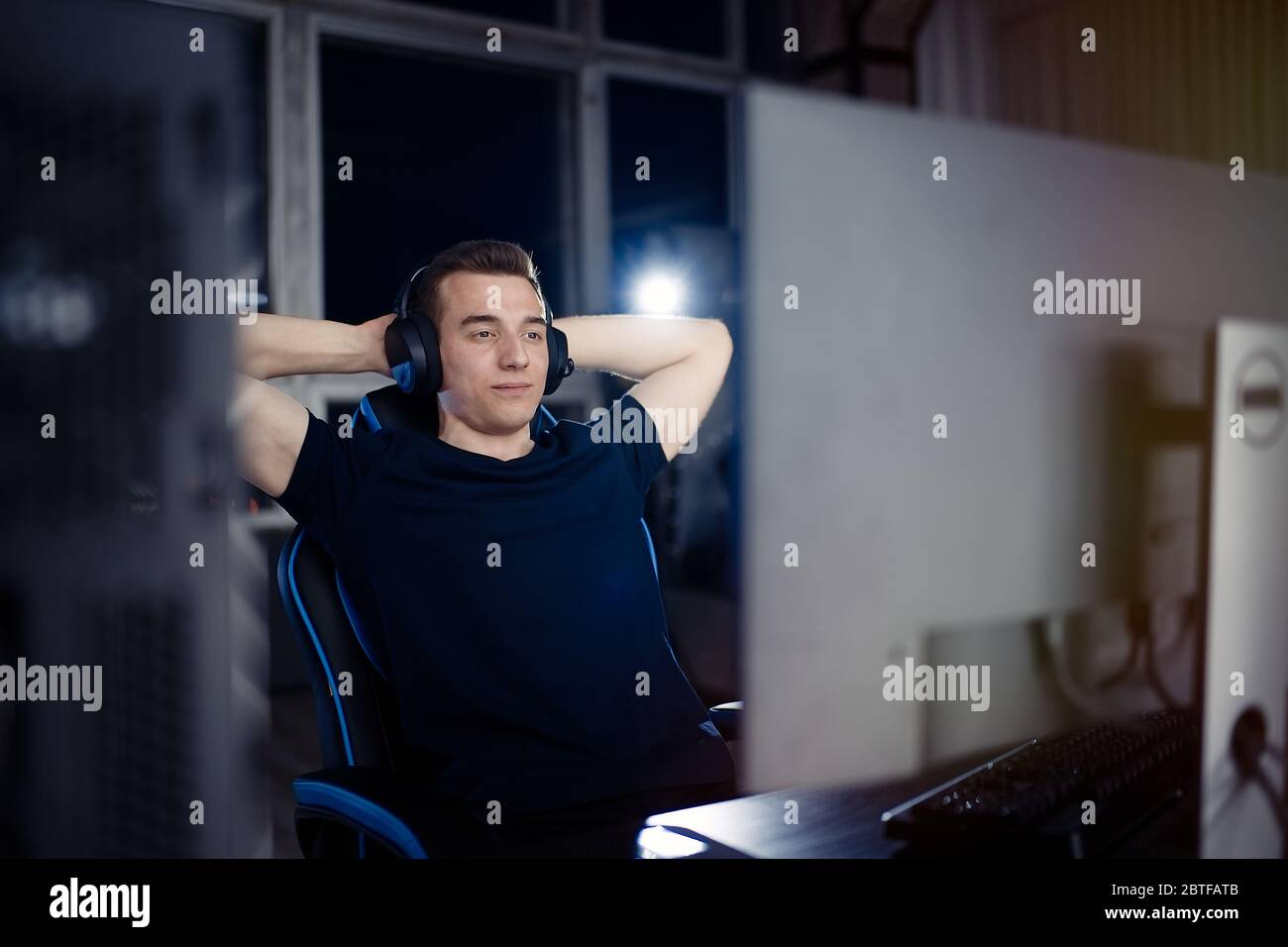 Young gamer playing online video games on computer and satisfied after ...