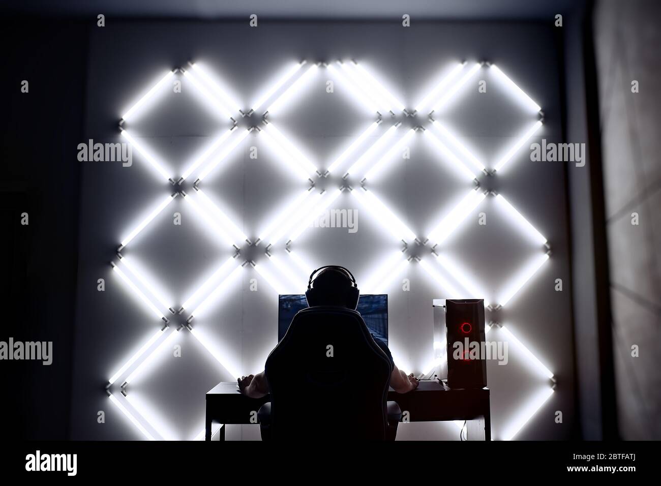 Professional gamer playing online video game at night time Stock Photo ...