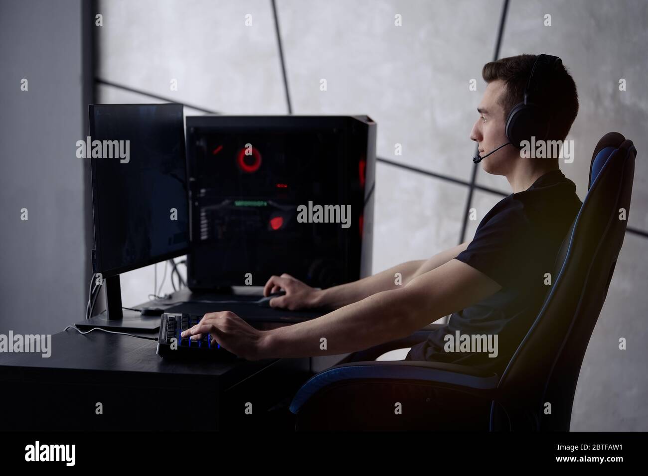 Professional gamer playing online video game at night time Stock Photo ...