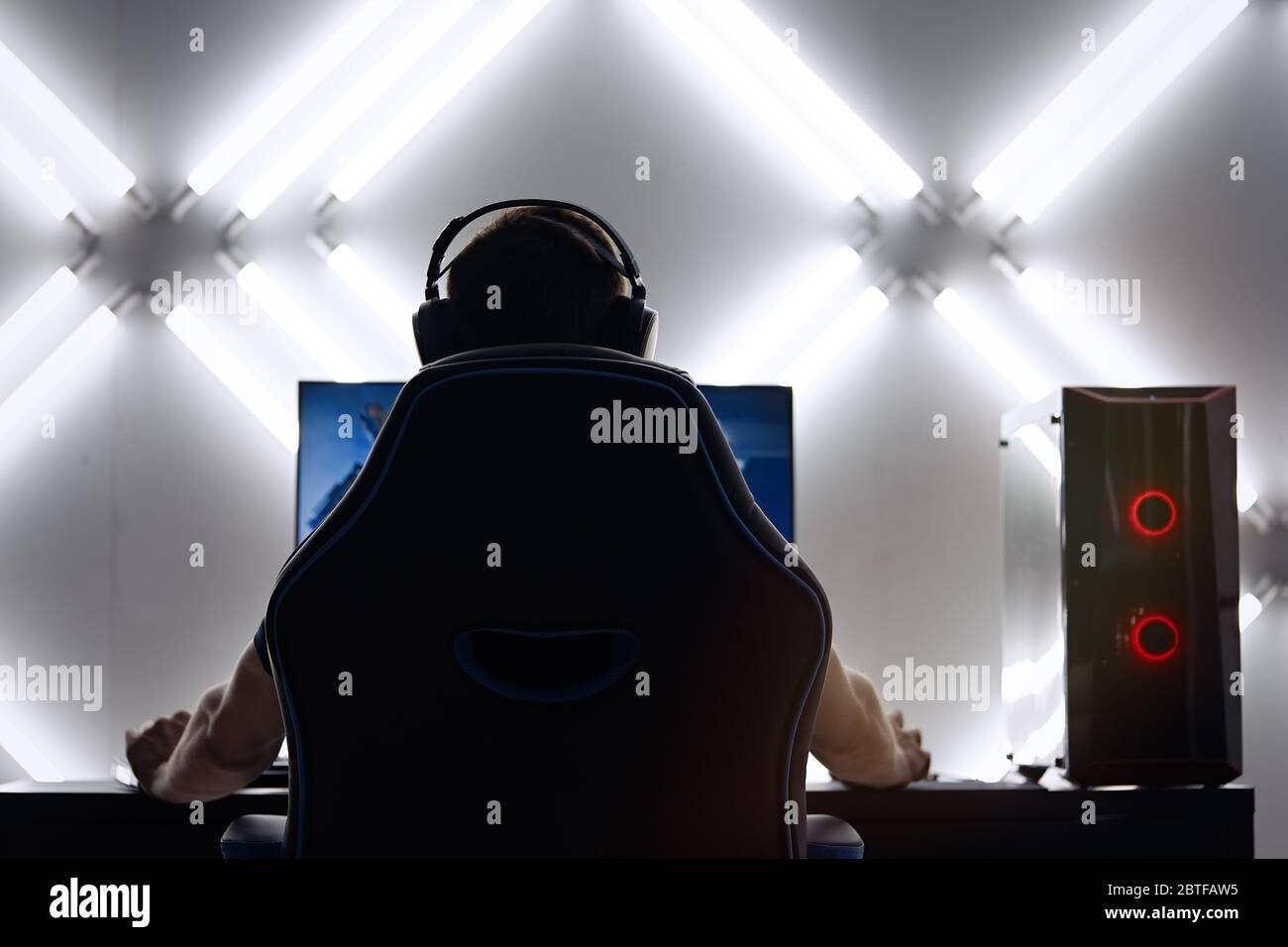 Professional gamer playing online video game at night time Stock Photo ...