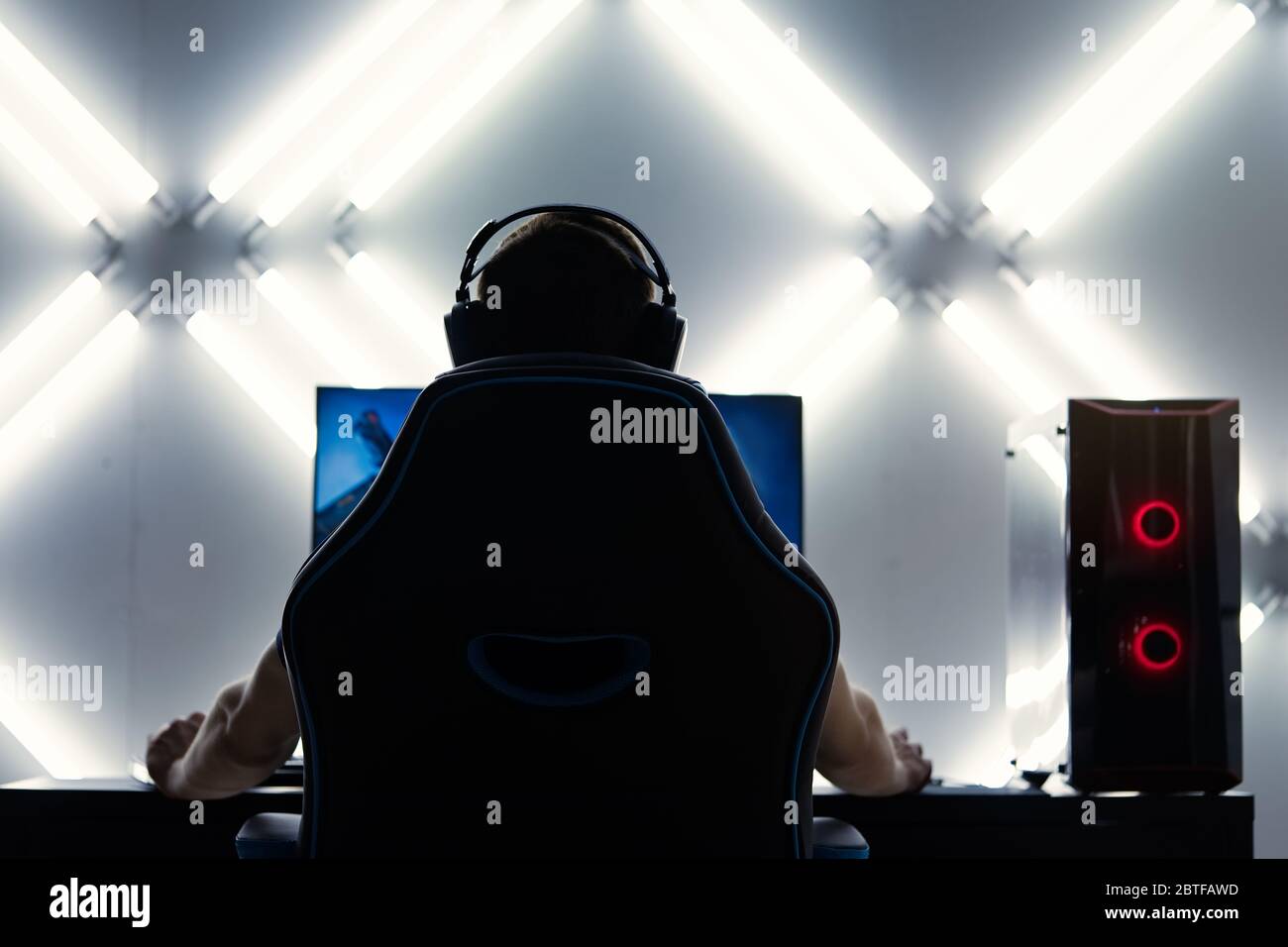 Professional gamer playing online video game at night time Stock Photo ...