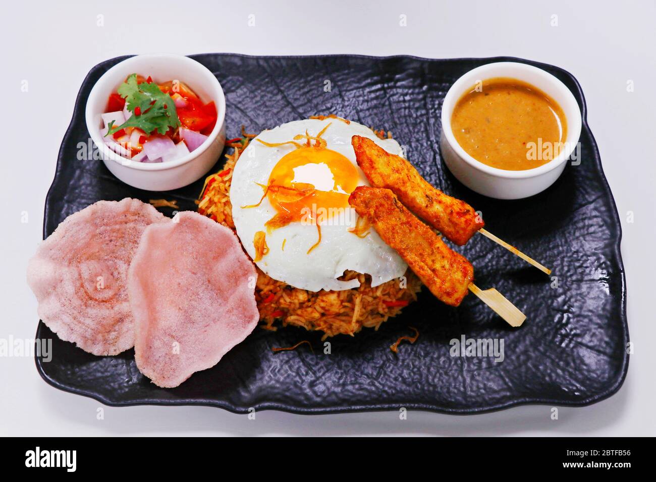 Nasi goreng, literally meaning fried rice in Indonesian, serve with ...