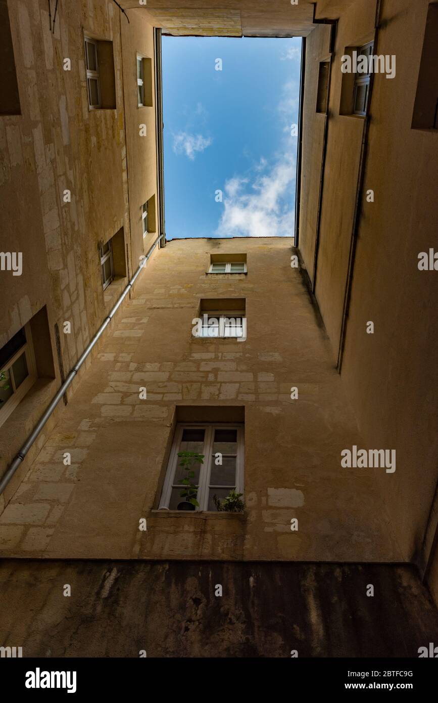Looking up through building courtyard skylight in old town Bordeaux ...