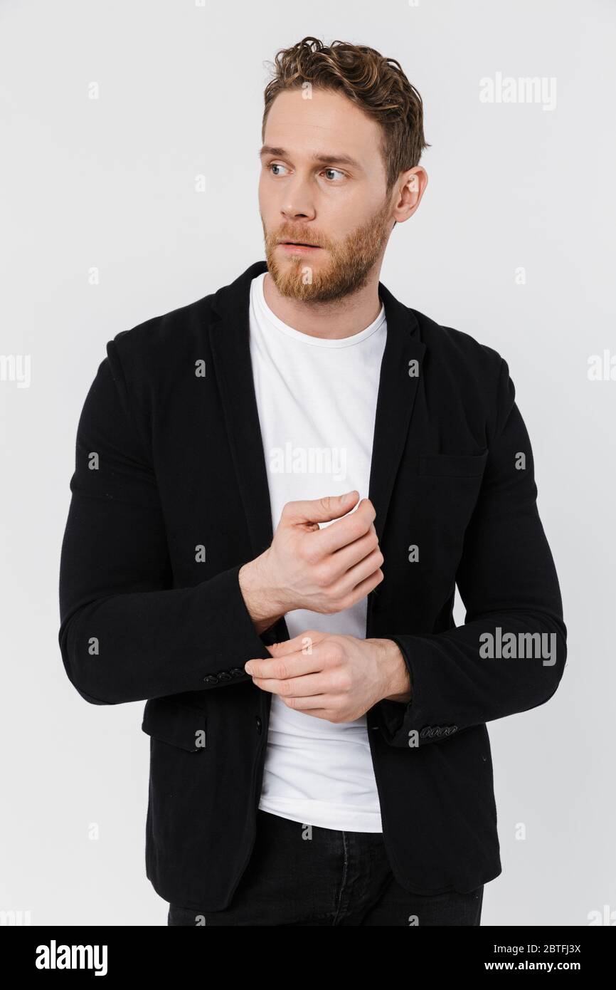 Image of unshaven serious man in jacket posing and looking aside ...