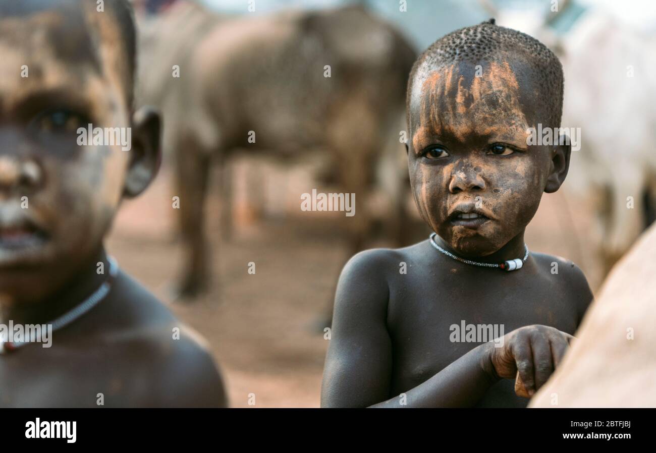 MUNDARI TRIBE, SOUTH SUDAN - MARCH 11, 2020: Child with mud on face ...