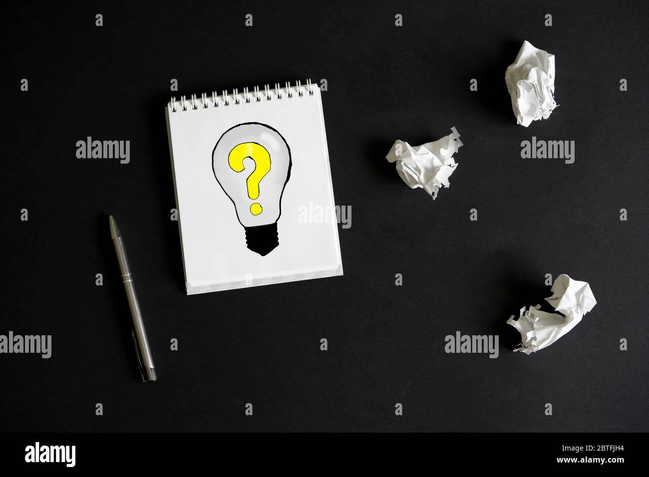 Pen And Crumpled Paper Near Notepad With Drawing Of Bulb With Question ...