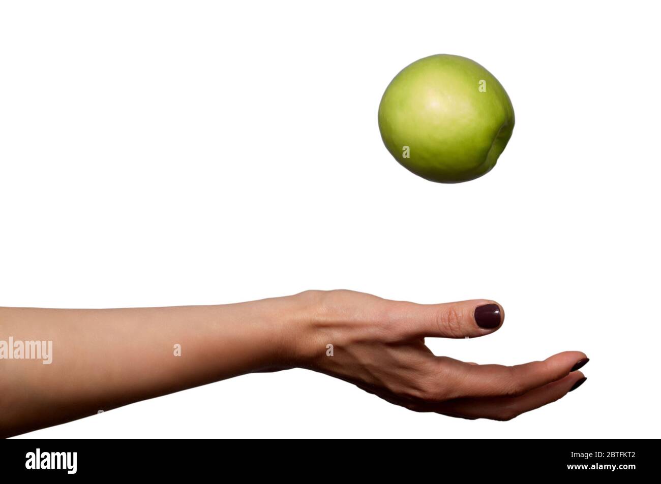 Hand tossing green apple in the air Stock Photo - Alamy