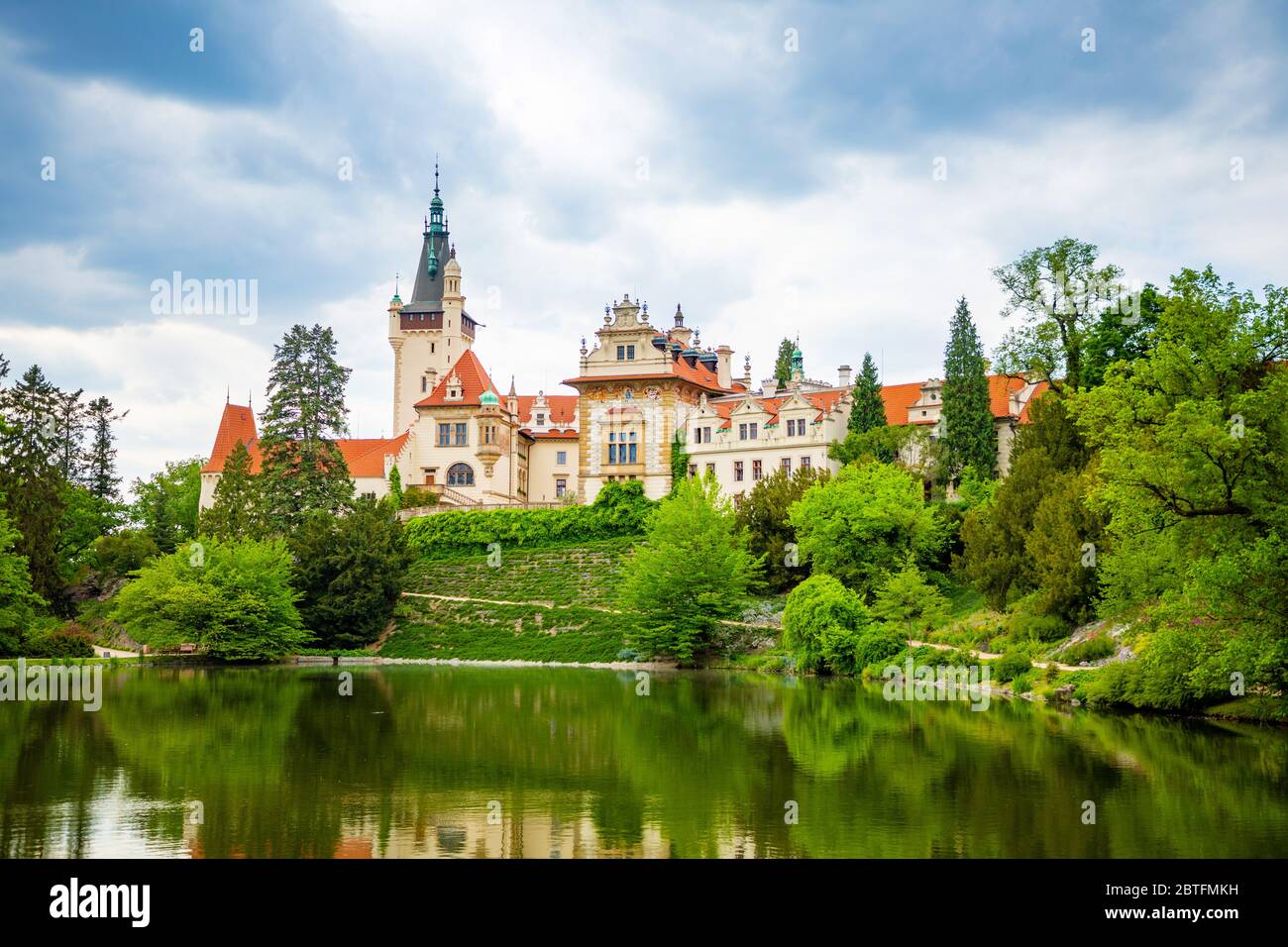 Castle with reflection in pond in spring time in Pruhonice, Czech ...
