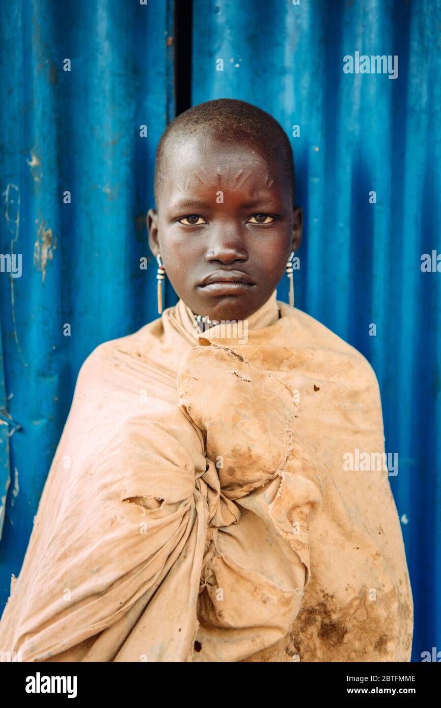 TOPOSA TRIBE, SOUTH SUDAN - MARCH 12, 2020: Teen girl looking at camera ...