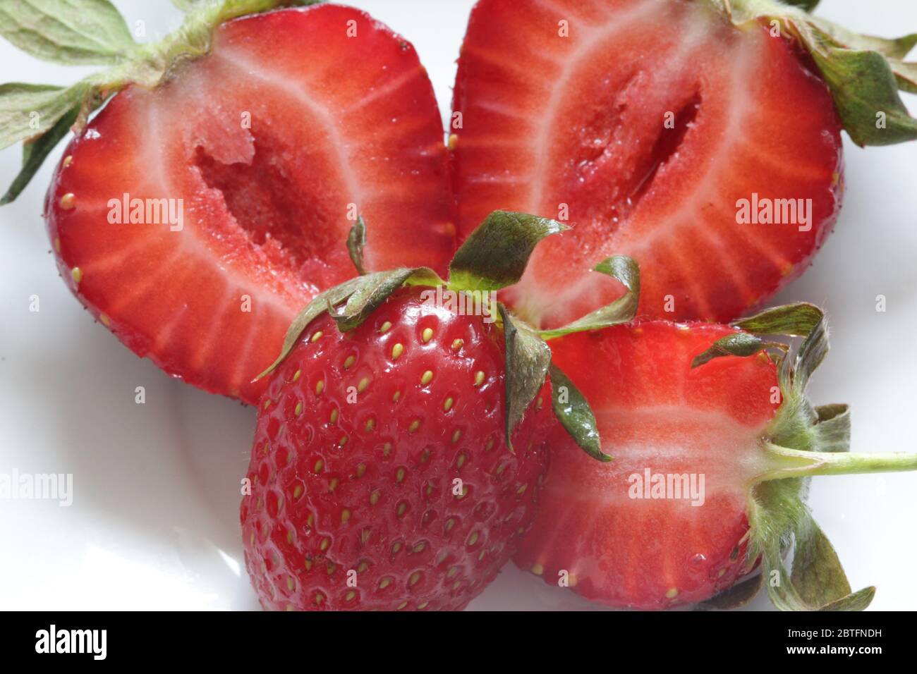 Strawberry cut in half hi-res stock photography and images - Alamy