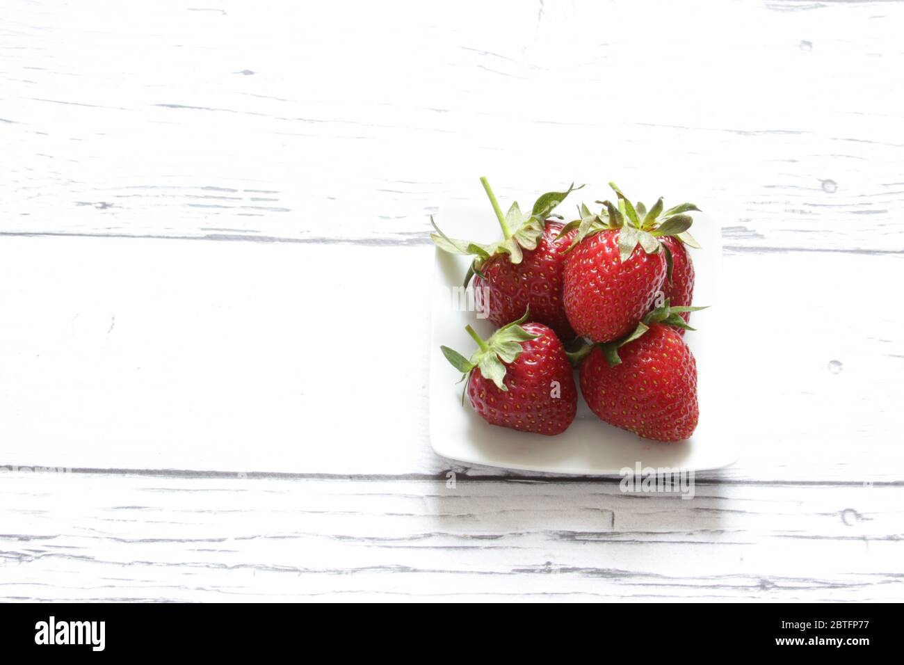 Fresh red strawberry cut in half on a white background. Healthy food ...