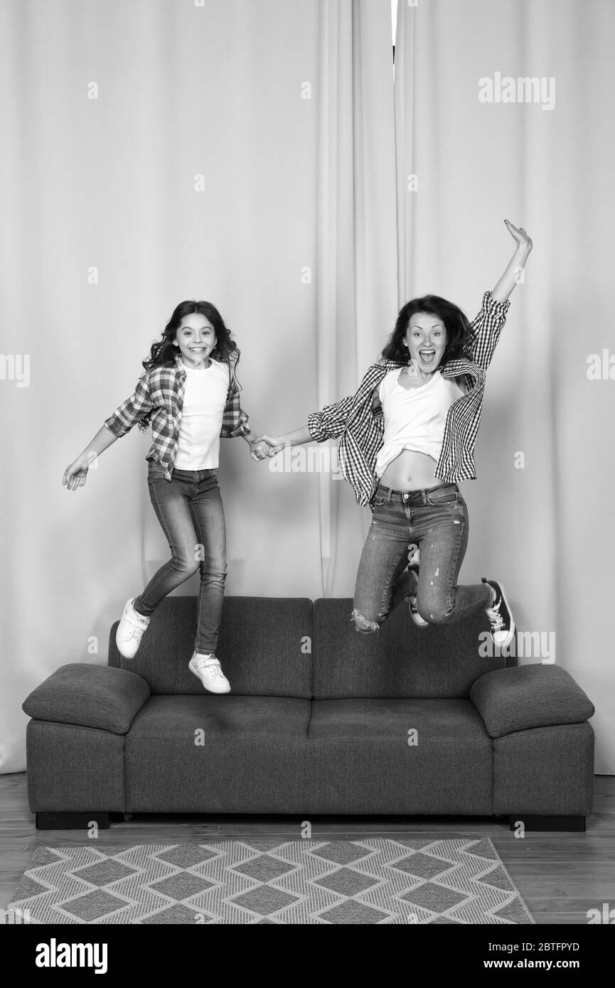 Girl jumping on sofa Black and White Stock Photos & Images - Alamy