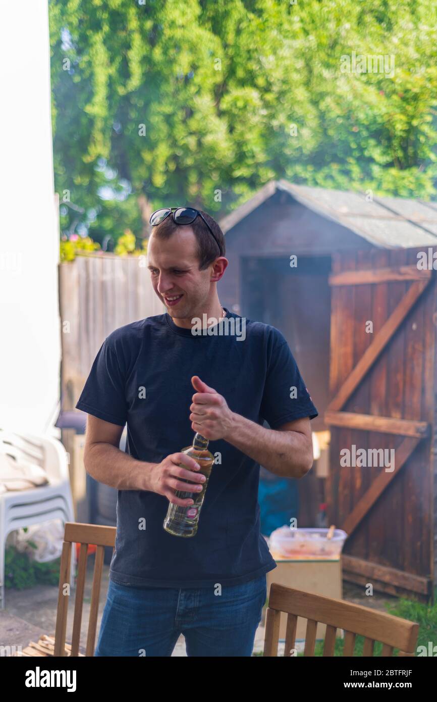 Russian man is opening a bottle of vodka ready to consume it Stock ...