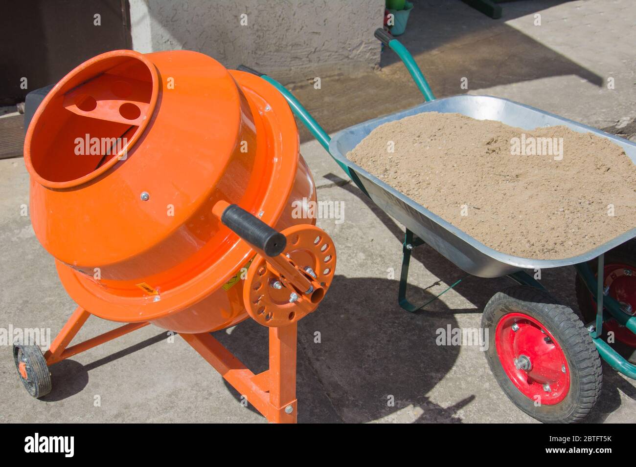 Process pouring the foundation. Orange concrete cement mixer machine is ...