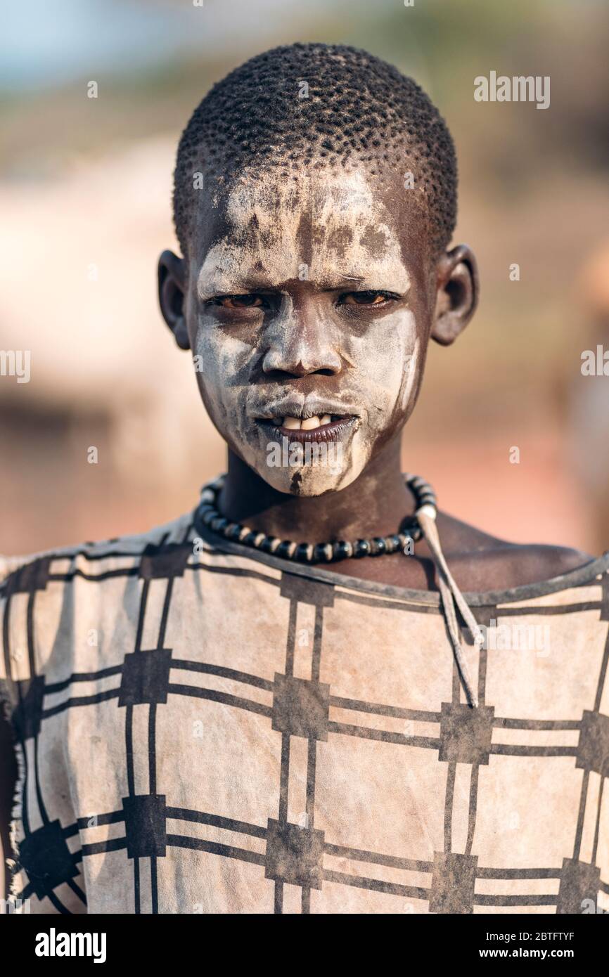 MUNDARI TRIBE, SOUTH SUDAN - MARCH 11, 2020: Teenager in traditional ...