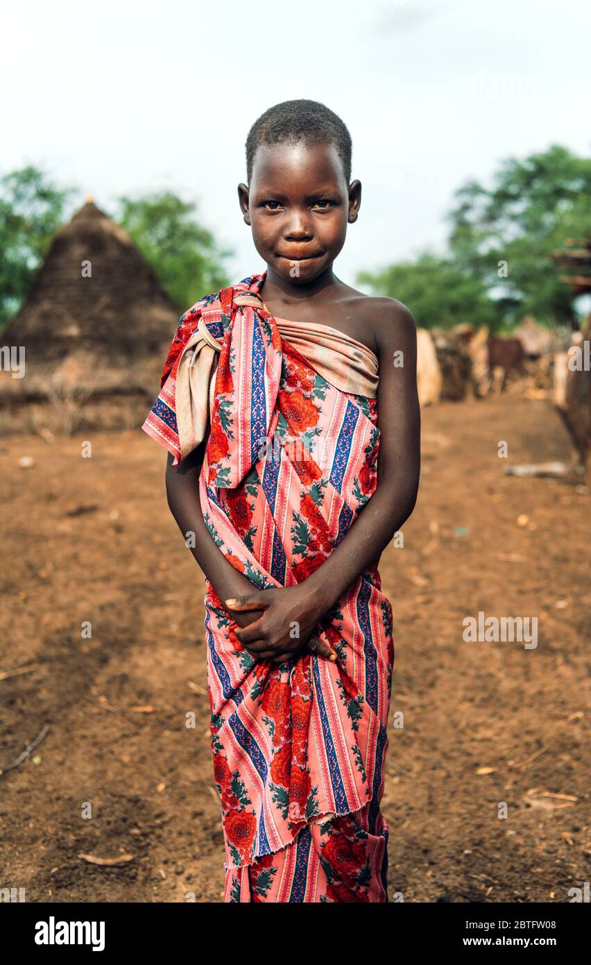 TOPOSA TRIBE, SOUTH SUDAN - MARCH 12, 2020: Girl wrapped in floral ...