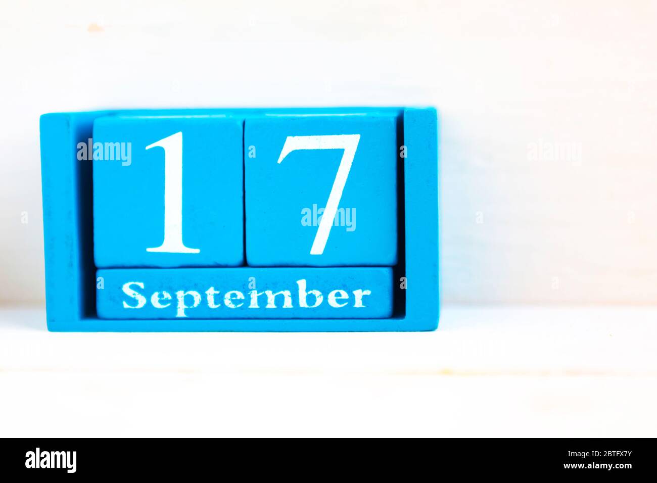 September 17, wooden background. Handmade wooden cube calendar with ...