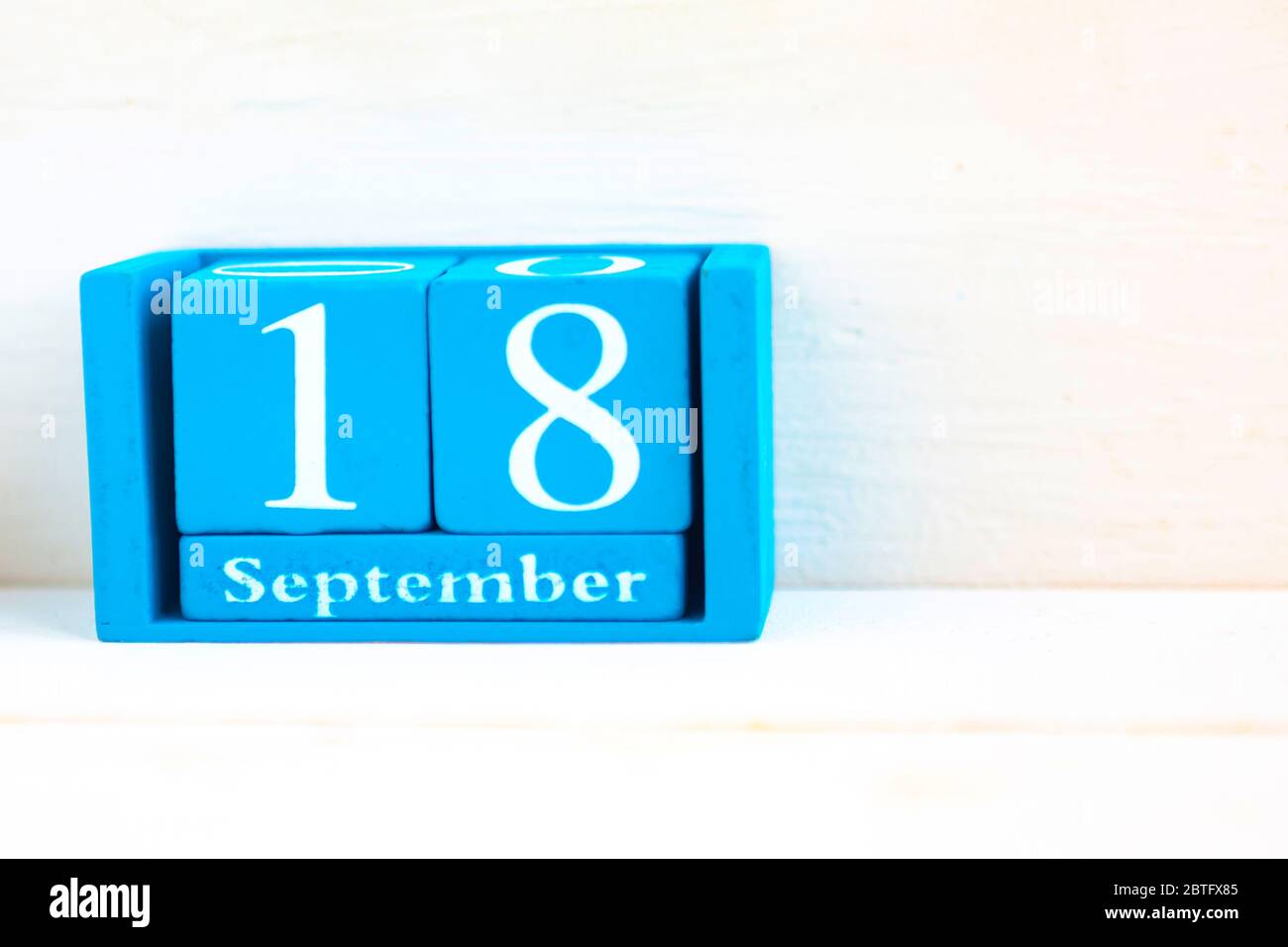 September 18, wooden background. Handmade wooden cube calendar with ...
