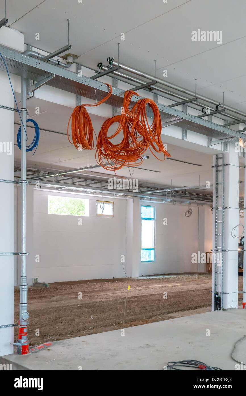 Inside a construction site many cables hang from the ceiling Stock ...