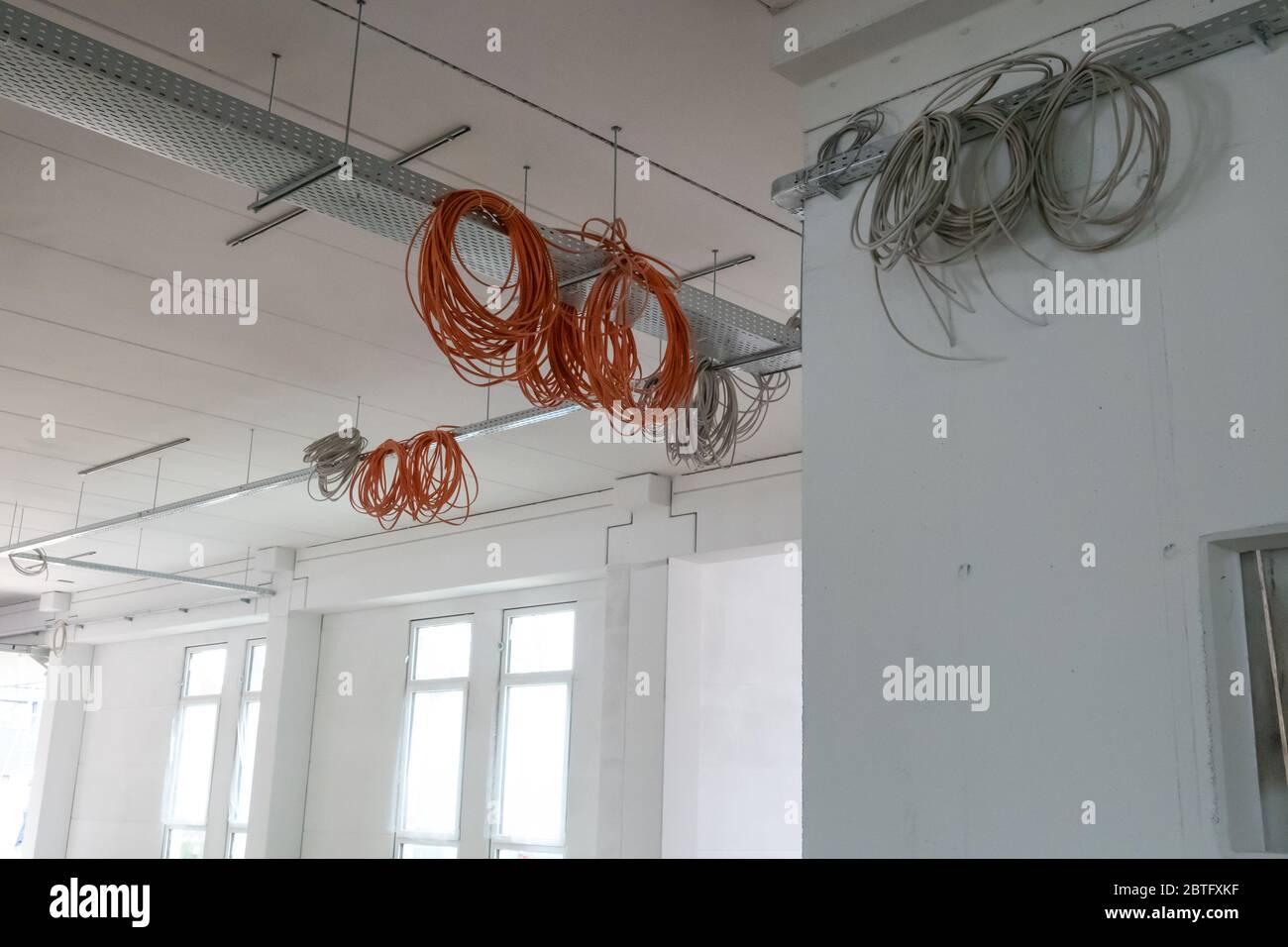 Inside a construction site many cables hang from the ceiling Stock ...