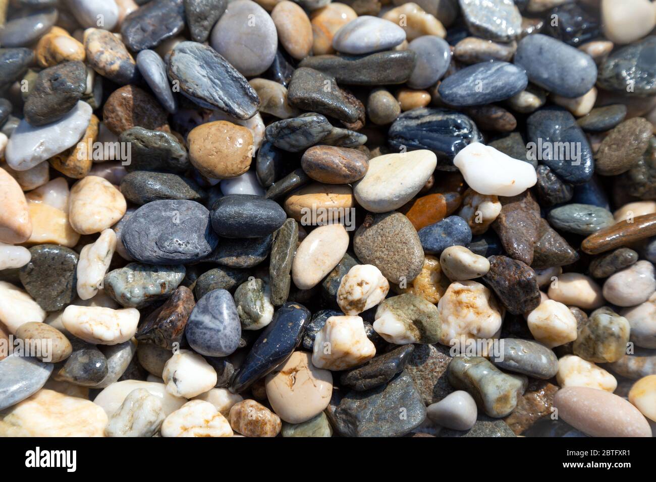 Abstract background with wet round reeble stones Stock Photo - Alamy