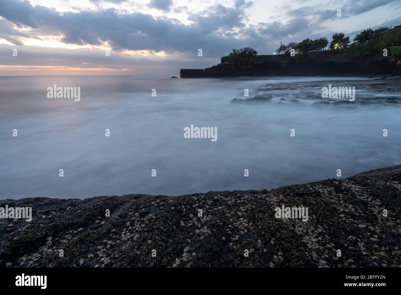cloudy dramatic sunset with sea waves in Pura Penataran Luhur Stock ...