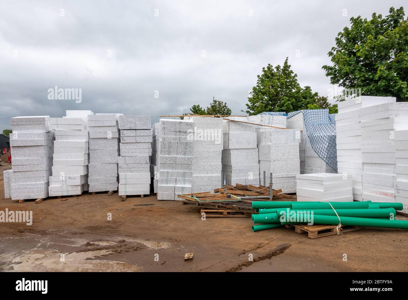 a large construction site there are many stacks of insulation boards ...