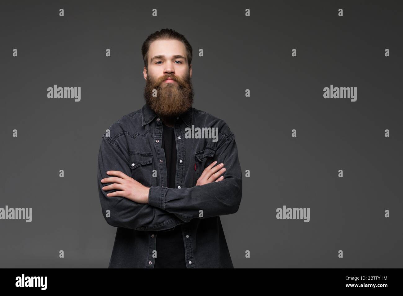Attractive long beard man hands crossed isolated grey color background ...