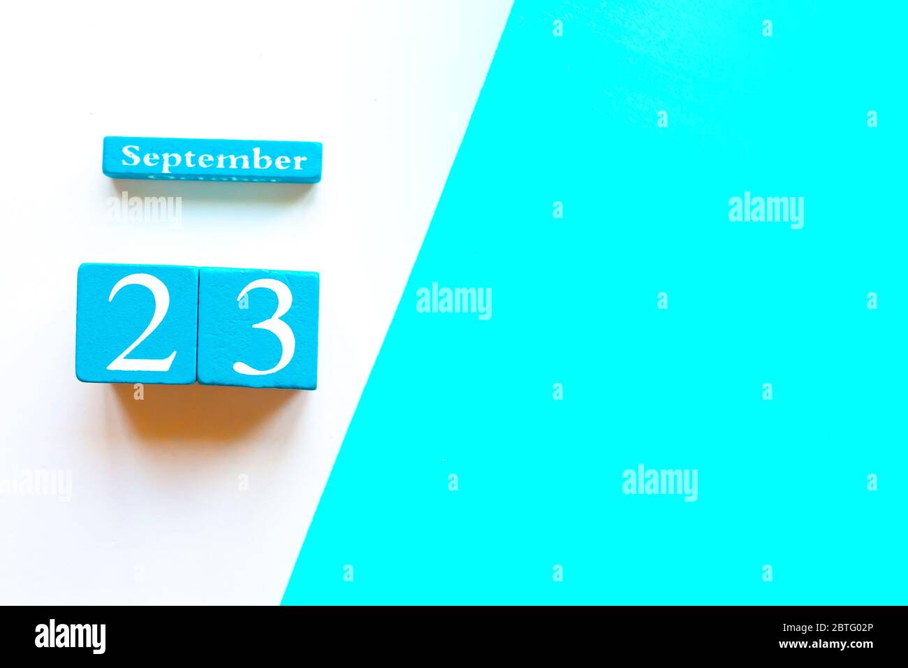 September 23, empty blue and white geometric background. Wooden ...