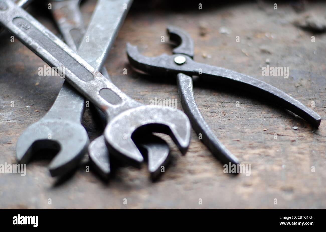 vintage iron work tools on a table Stock Photo - Alamy