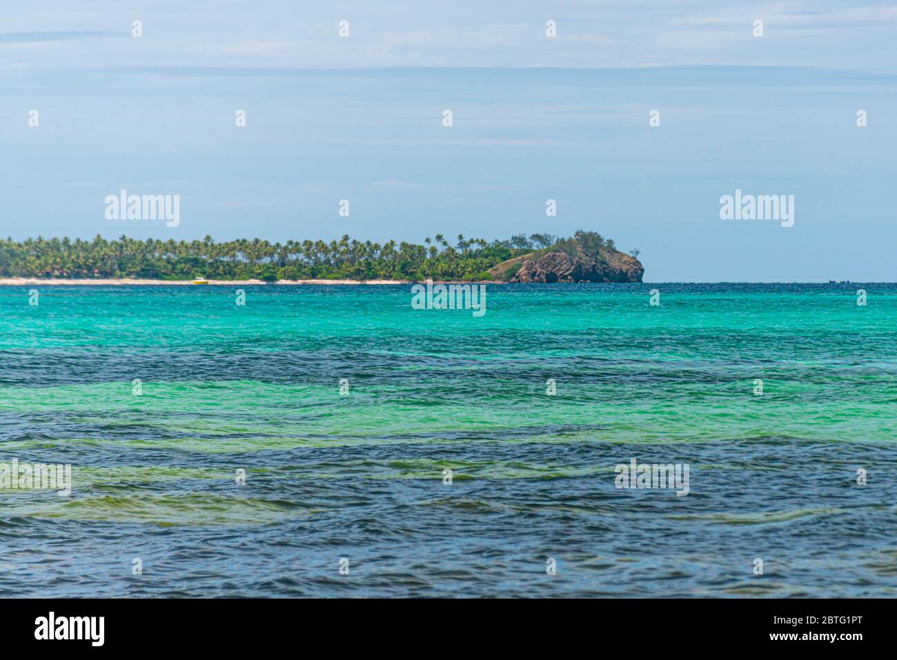 Shades of turquoise blue water with reefs. A tropical island with a ...