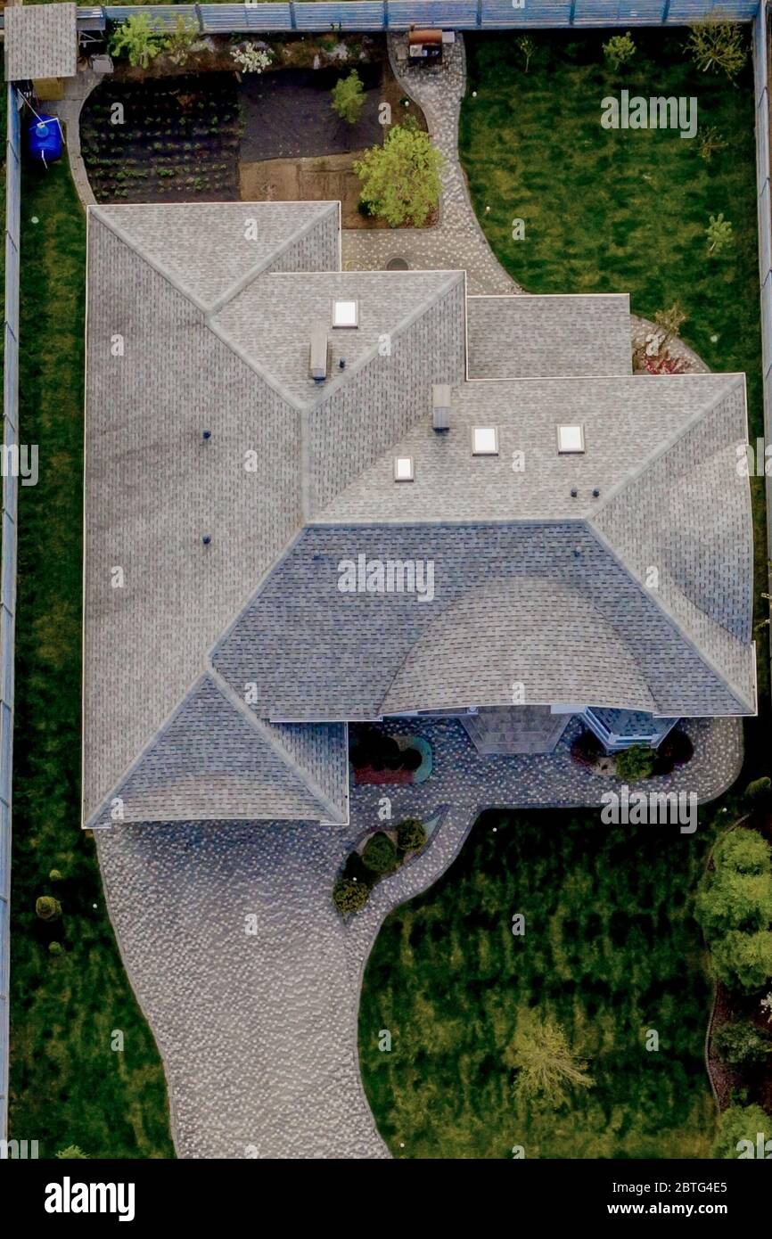 Aerial top view of a private house with paved yard with green grass ...