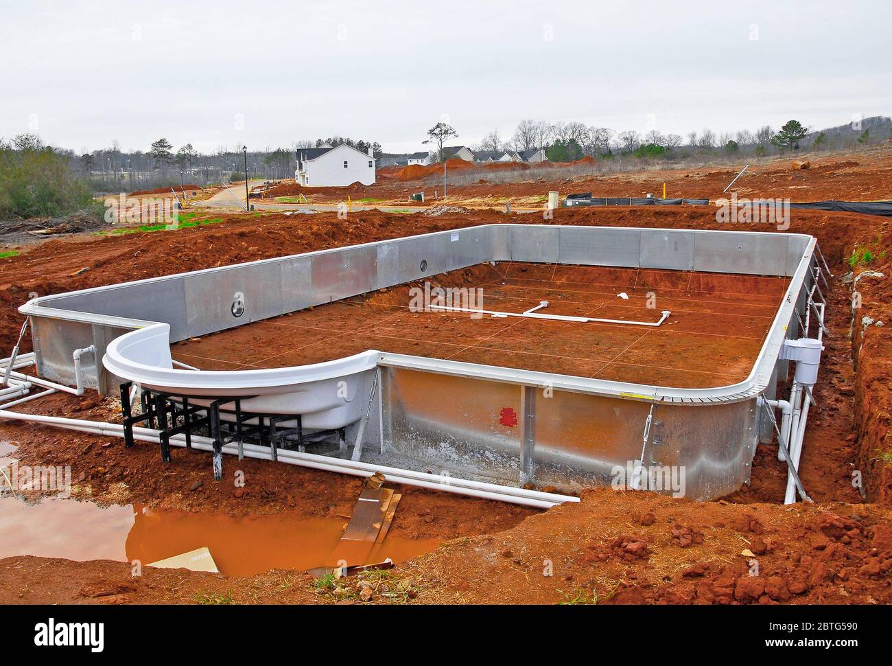 A New In Ground Swimming Pool being installed in a New Housing ...