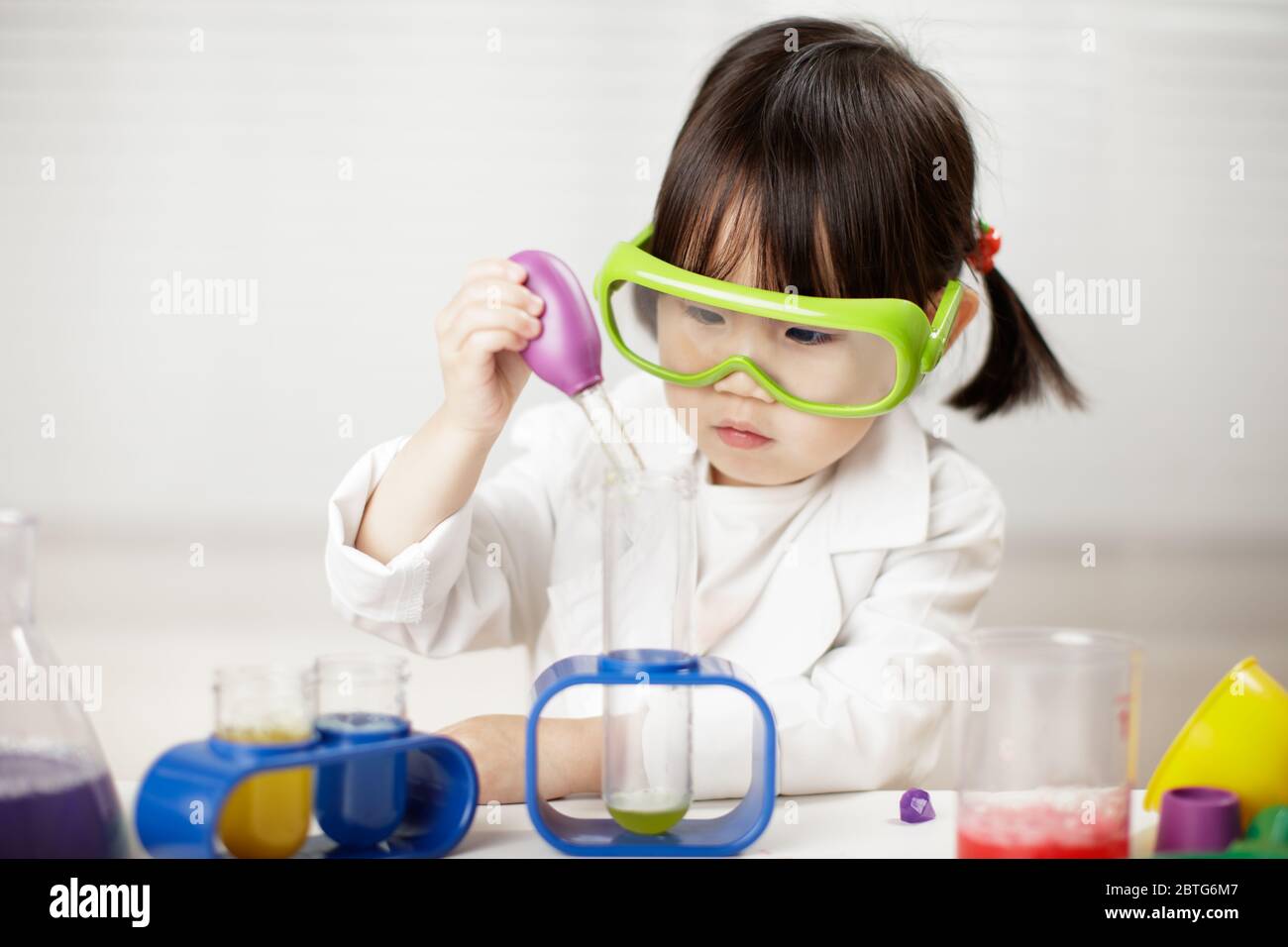 toddler girl pretend play scientist role for homeschooling Stock Photo ...