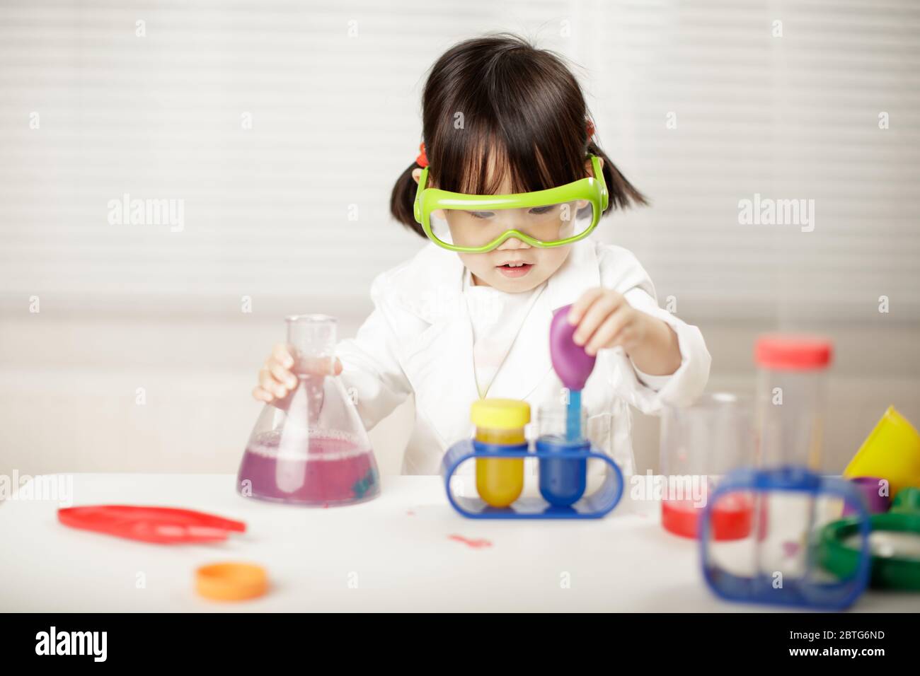 toddler girl pretend play scientist role for homeschooling Stock Photo ...
