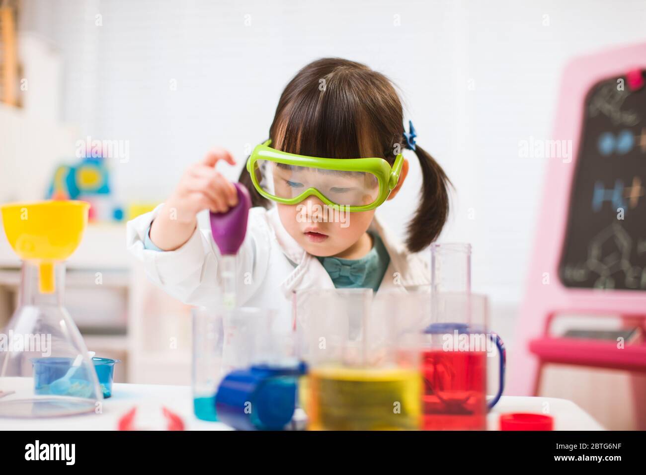 toddler girl pretend play scientist role for homeschooling Stock Photo ...