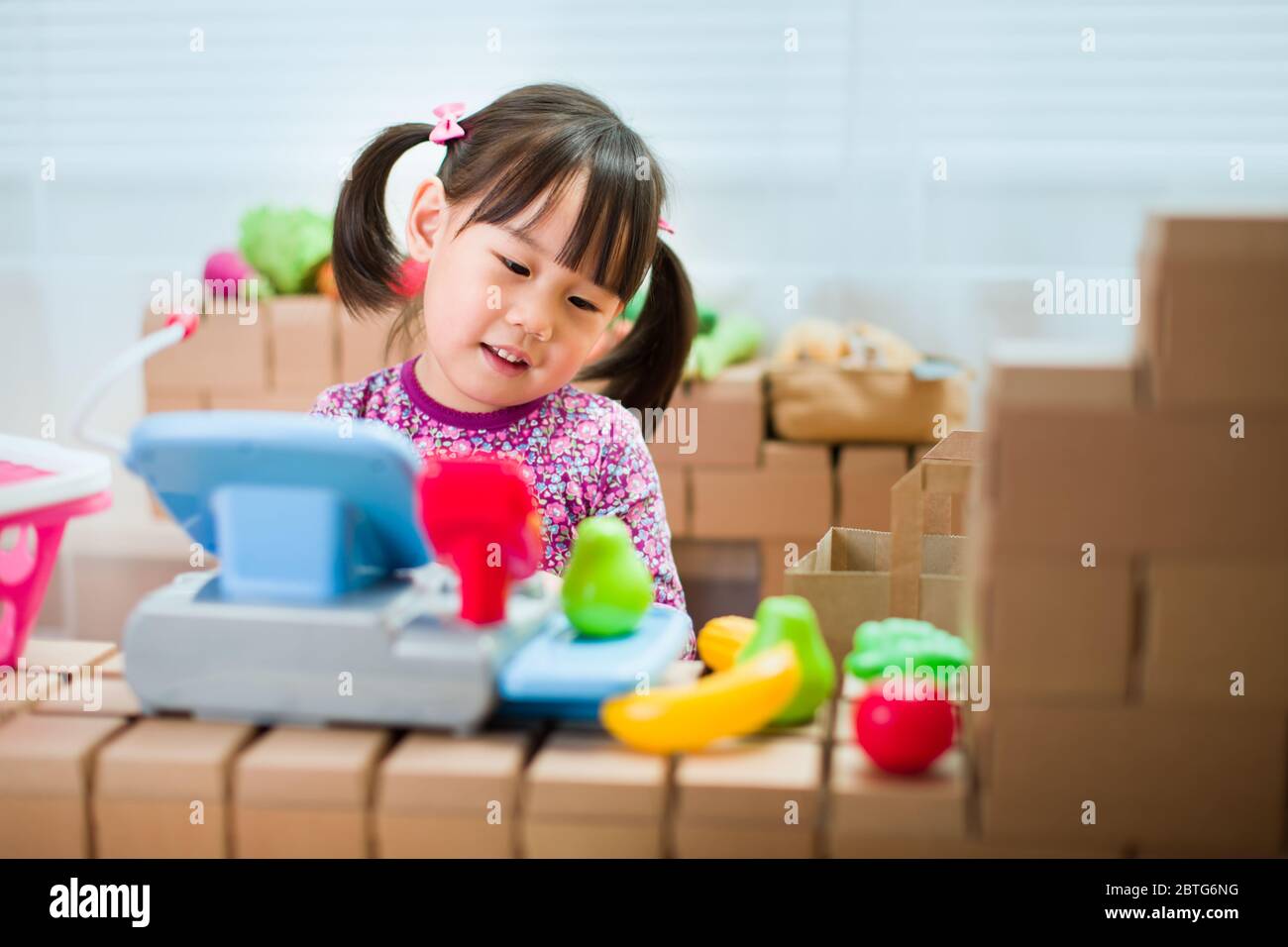 toddler girl pretend play sweet shop keeper at home Stock Photo - Alamy