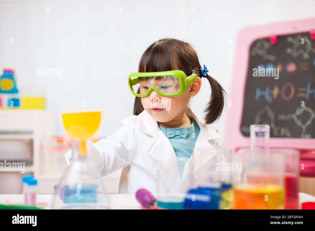 toddler girl pretend play scientist role for homeschooling Stock Photo ...