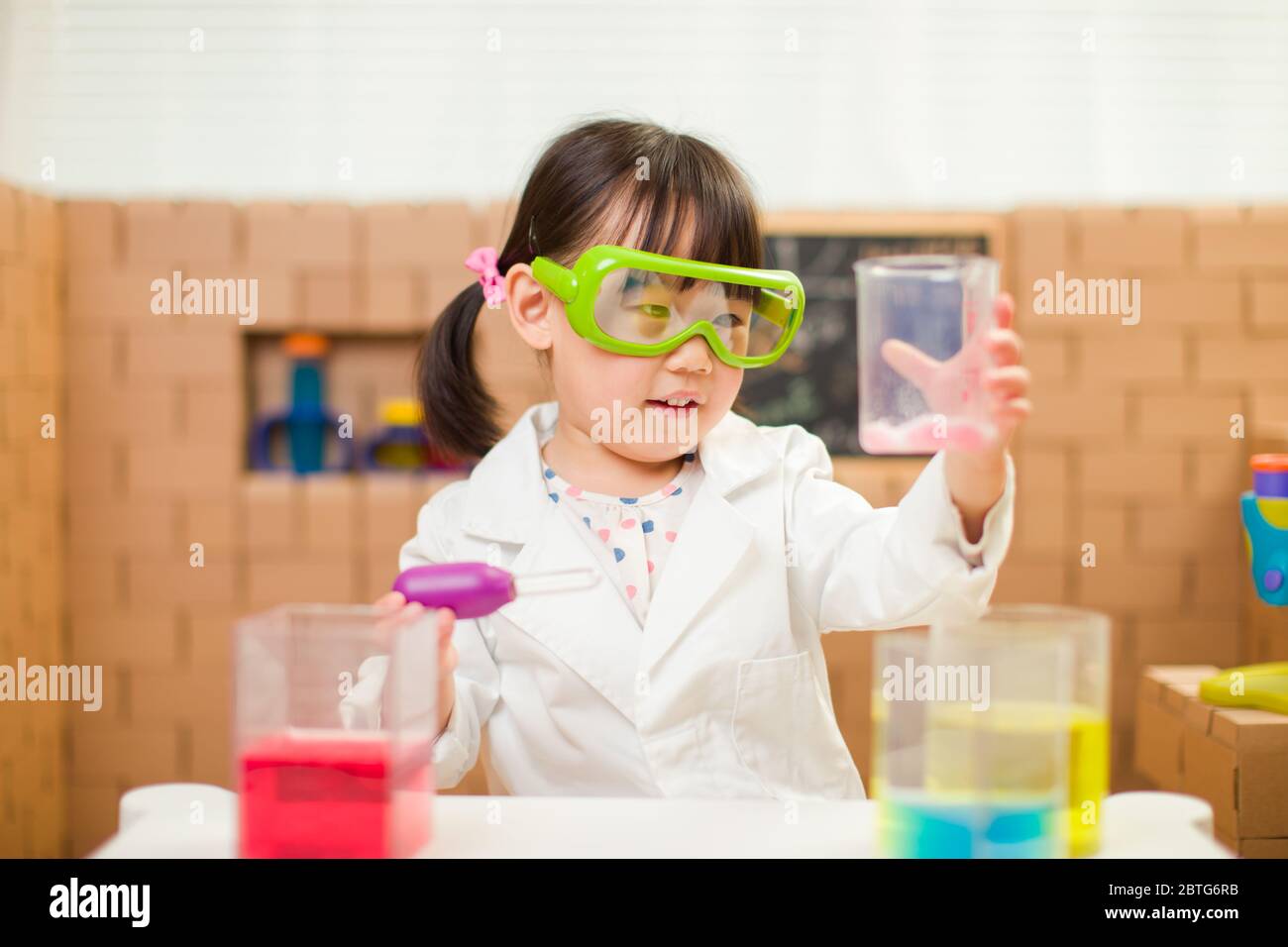 toddler girl pretend play scientist role for homeschooling Stock Photo ...