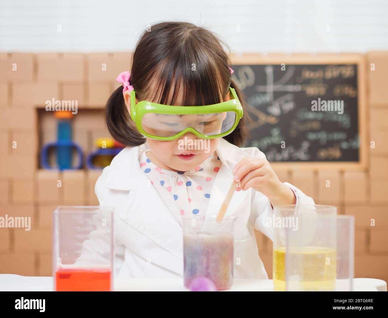toddler girl pretend play scientist role for homeschooling Stock Photo ...